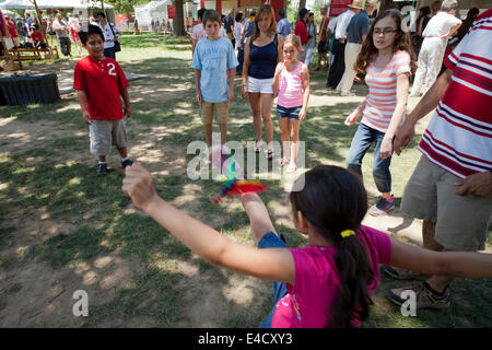 Kids playing jianzi (Chinese shuttlecock) at a cultural festival ...
