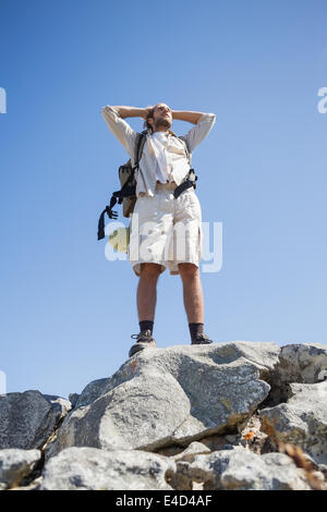 Handsome hiker standing at the summit Stock Photo - Alamy