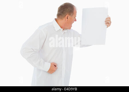 Angry man shouting at piece of paper Stock Photo - Alamy