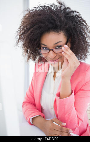 Portrait of graphic designer working at desk with colleague in office ...