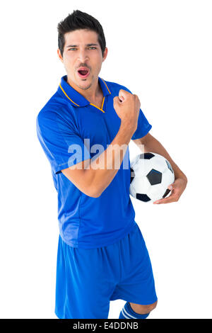 Happy football player in blue celebrating on white background Stock ...