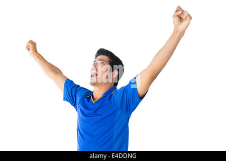 Happy football player in blue celebrating on white background Stock ...