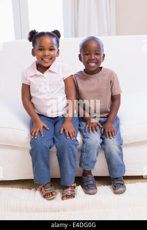 Happy siblings smiling at camera together Stock Photo - Alamy