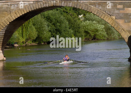 Two woman rowers on the River Severn at Bewdley, rowing under bridge ...