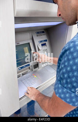 A male using an ATM machine Stock Photo - Alamy