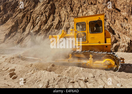Bulldozer doing mountain road construction in Himalayas. Himachal ...