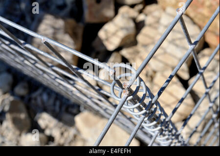Gabion is a wire cage filled with rocks for use in civil engineering ...