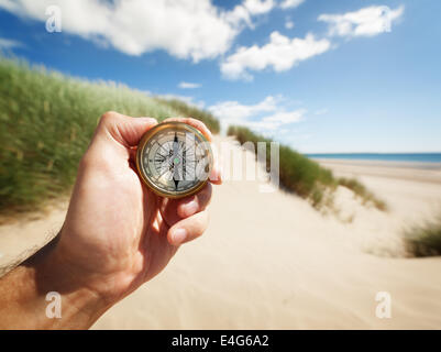 Hand holding Compass for finding direction Stock Photo - Alamy