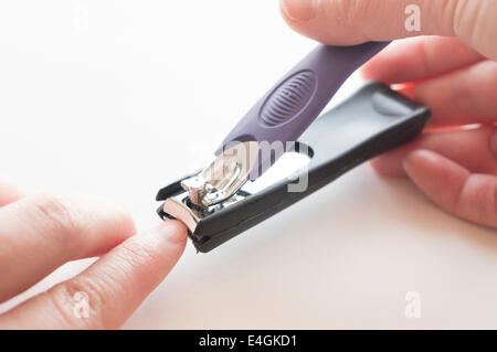 Hand manicure with nail clipper Stock Photo - Alamy