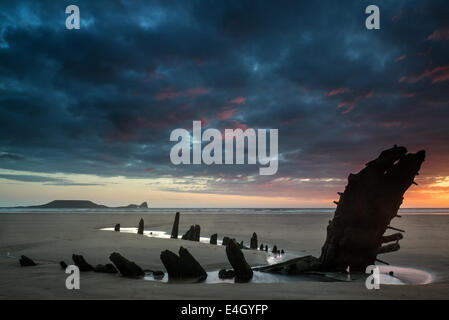 Dramatic sunset landscape over shipwreck on Rhosilli Bay beach Stock ...