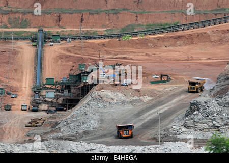 Excavator and heavy mining dump trucks in a limestone quarry, loading ...