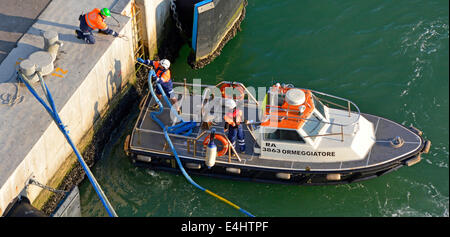 Aerial view motorboat & mooring crew release cruise ship hawsers fixed ...