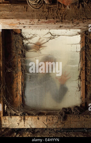 Photo of a zombie outside a window that is covered with blood ...