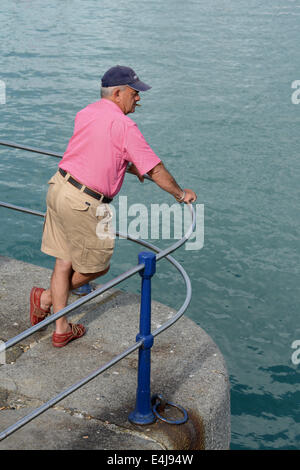 man leaning on railing Stock Photo - Alamy