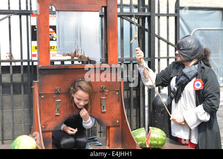 Borough Market, London, UK. 13th July 2014. The Guillotine entertains ...
