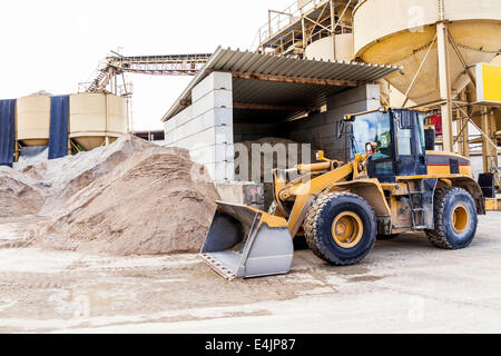 Parked pay loader near pile of dirt at a construction site Stock Photo ...