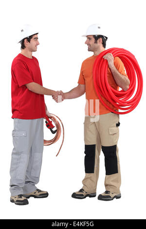 Plumbers shaking hands Stock Photo - Alamy