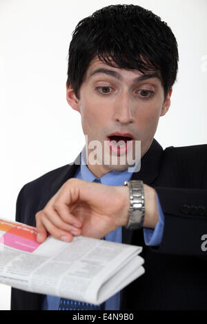 Shocked young man panicking, holding hands on head and staring ...