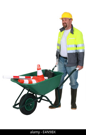 Manual worker pushing a wheelbarrow Stock Photo - Alamy