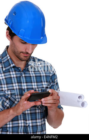 Architect sending text message Stock Photo - Alamy