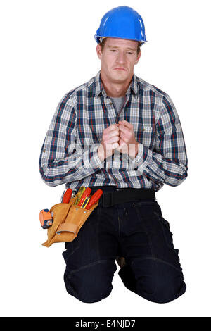 Desperate adult builder man with sad expression begging asking money ...
