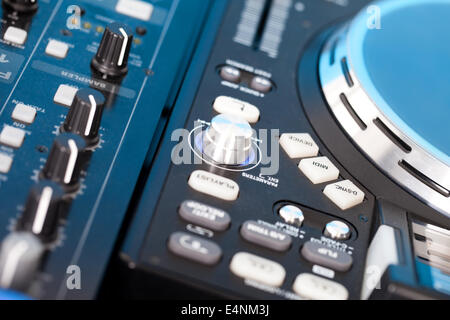 Closeup detail of a DJs music deck with turntable and control knobs for ...