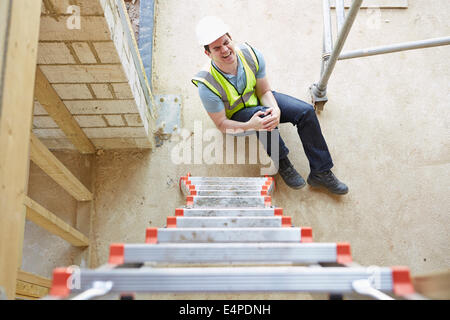 Construction Worker Falling Off Ladder And Injuring Leg Stock Photo - Alamy