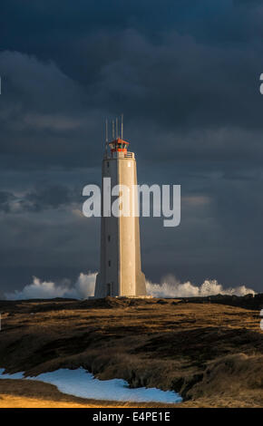 Lighthouse on the coast on a cloudy day Stock Photo - Alamy