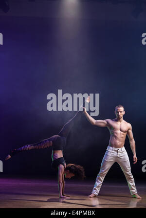 A man and a woman performing a contemporary dance pose on a stage Stock ...
