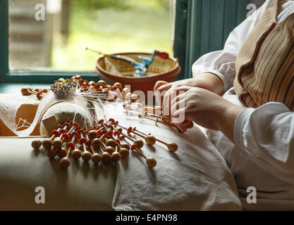 Bobbin lace being produced with the traditional method by hand with ...