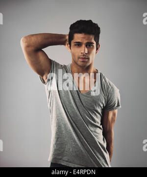 Young handsome hispanic man standing over isolated background smiling ...