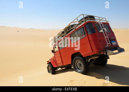 A tour guide driving a jeep down a highway in the desert in Egypt Stock ...