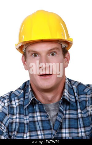 Scared and confused male contractor looking at room and determining ...