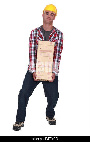 Construction worker lifting a heavy brick isolated in white Stock Photo ...