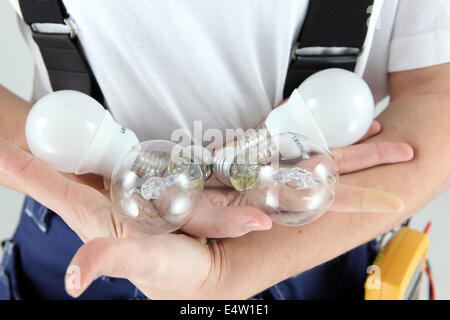 Female electrician with lightbulbs Stock Photo - Alamy