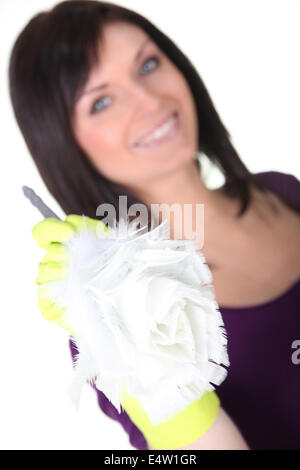 Maid holding feather duster Stock Photo - Alamy