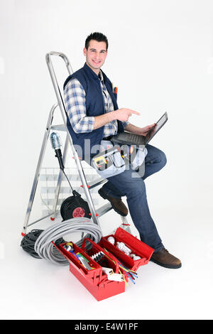 A man on a step ladder is installing a mosquito net, fly screen or ...