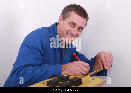Plumber marking copper pipe Stock Photo - Alamy