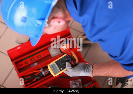 Man with electricity measurer Stock Photo - Alamy