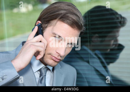 young goodlooking man on his phone Stock Photo - Alamy