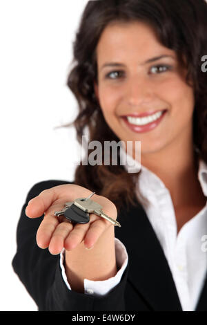 Hand giving keys Stock Photo - Alamy