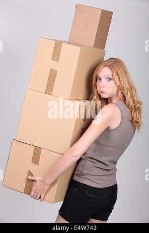 Woman carrying heavy boxes Stock Photo - Alamy