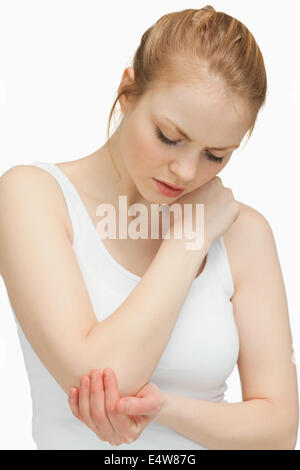 Woman touching her painful elbow Stock Photo - Alamy