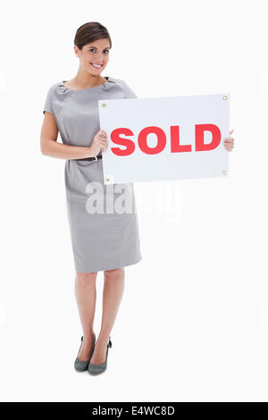 Sold sign board in hands of happy diverse couple who bought new house ...