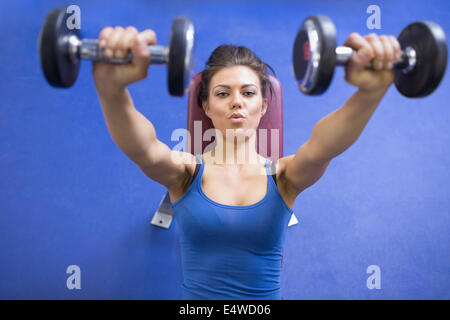 Woman energetically lifting weights Stock Photo - Alamy