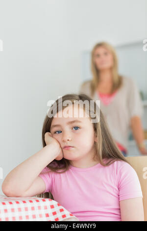 Little girl sitting looking exasperated Stock Photo - Alamy