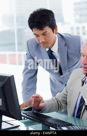 Portrait of corporate managers working together in office interior ...