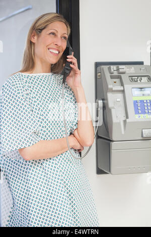 Happy patient using payphone Stock Photo - Alamy