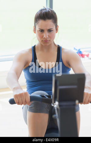 Focused woman at the rowing machine Stock Photo - Alamy