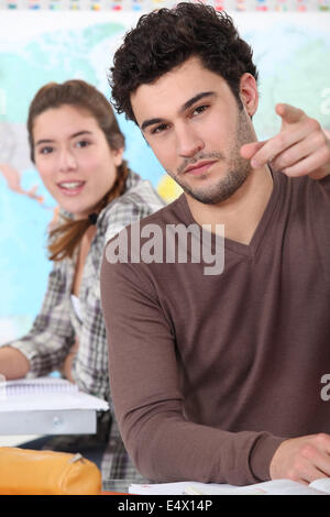 Students in a classroom - handsome student solving a math problem on a ...